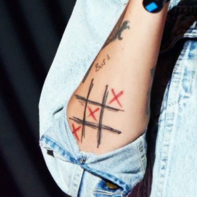 Louis Tomlinson’s 12 Tattoos & Their Meanings